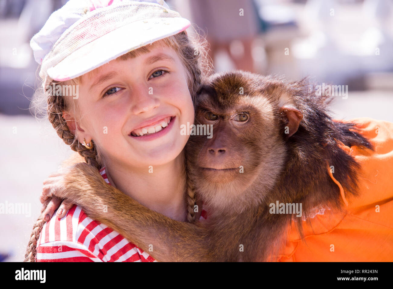 pet monkey hugging a girl on the street Stock Photo - Alamy