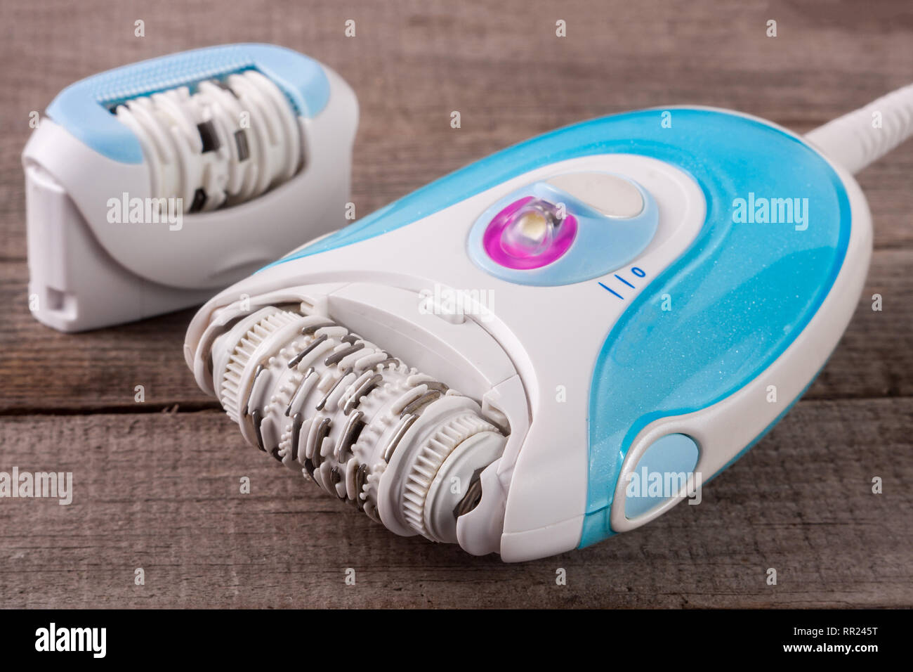 electric epilator hair on an old wooden background Stock Photo - Alamy