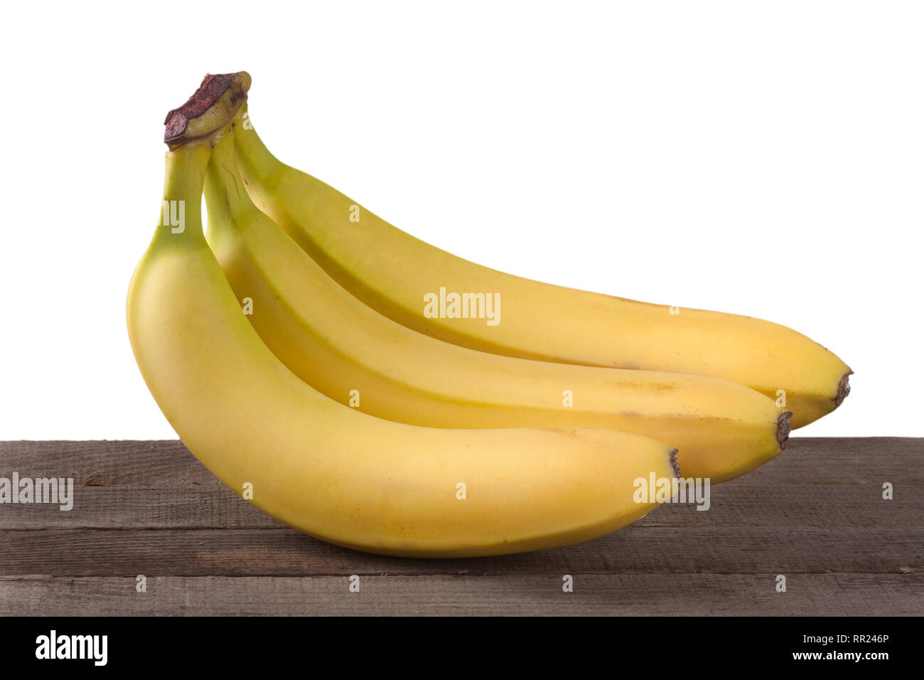 Three bananas on a wooden board isolated white background Stock Photo ...