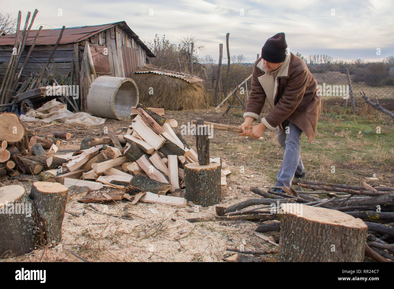 man chopping wood in the village Stock Photo - Alamy