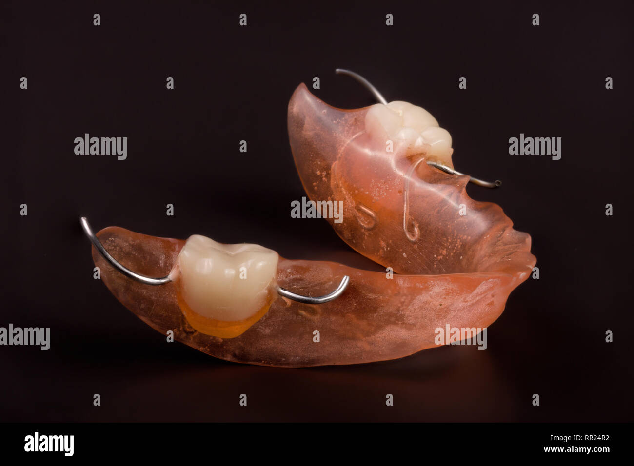 removable partial denture on a dark background Stock Photo - Alamy
