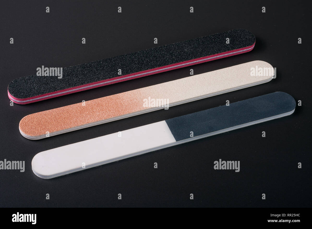Three nail file with a different abrasive on dark background Stock ...