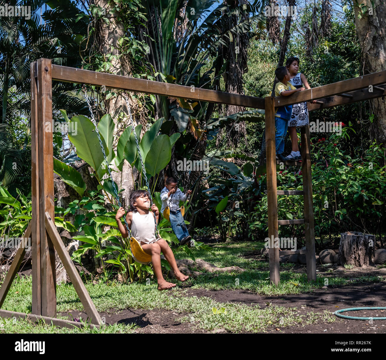 latin family playing on playground in Guatemala Stock Photo - Alamy