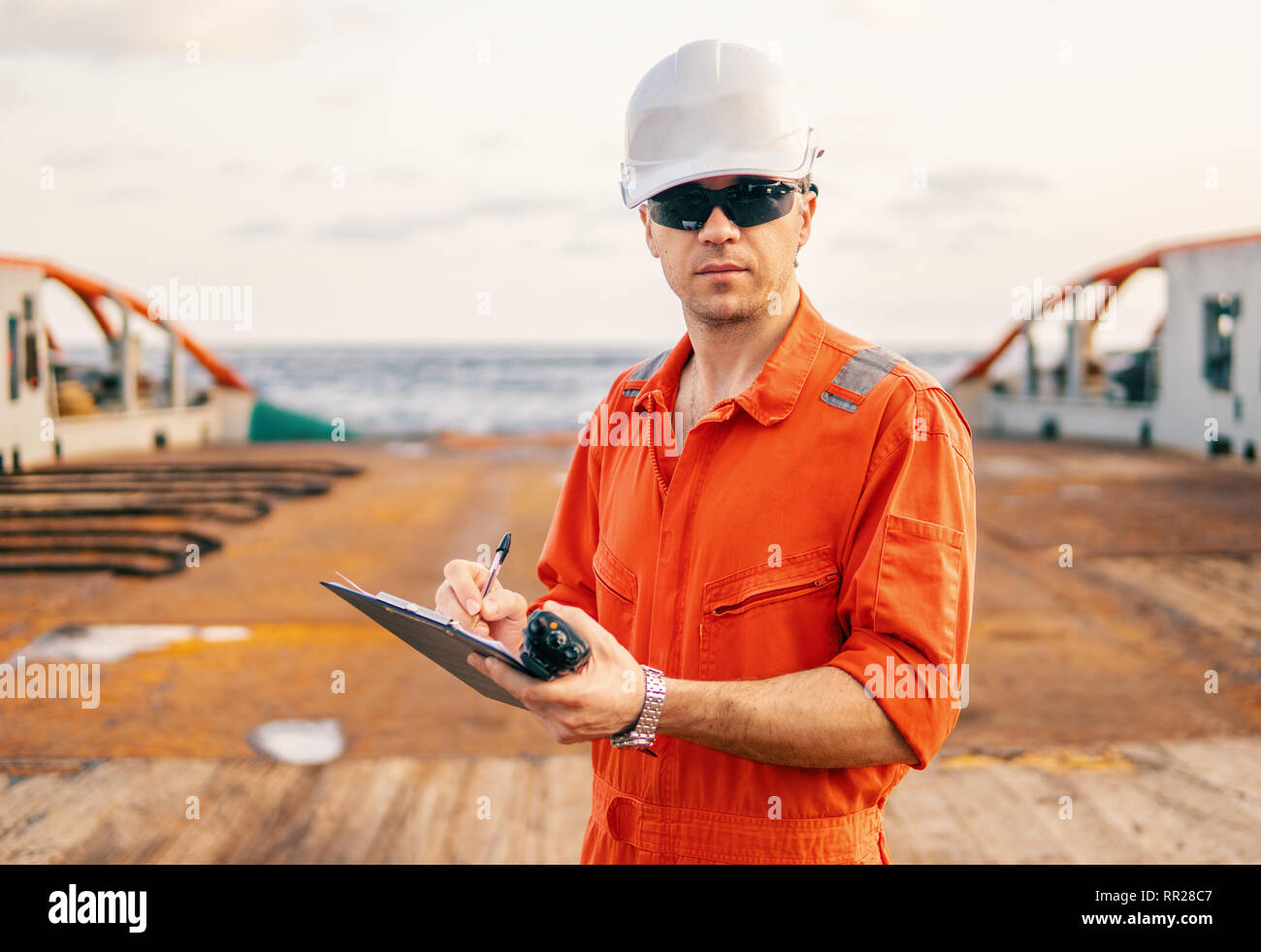 chief officer on deck of ship or vessel with checklist Stock Photo - Alamy
