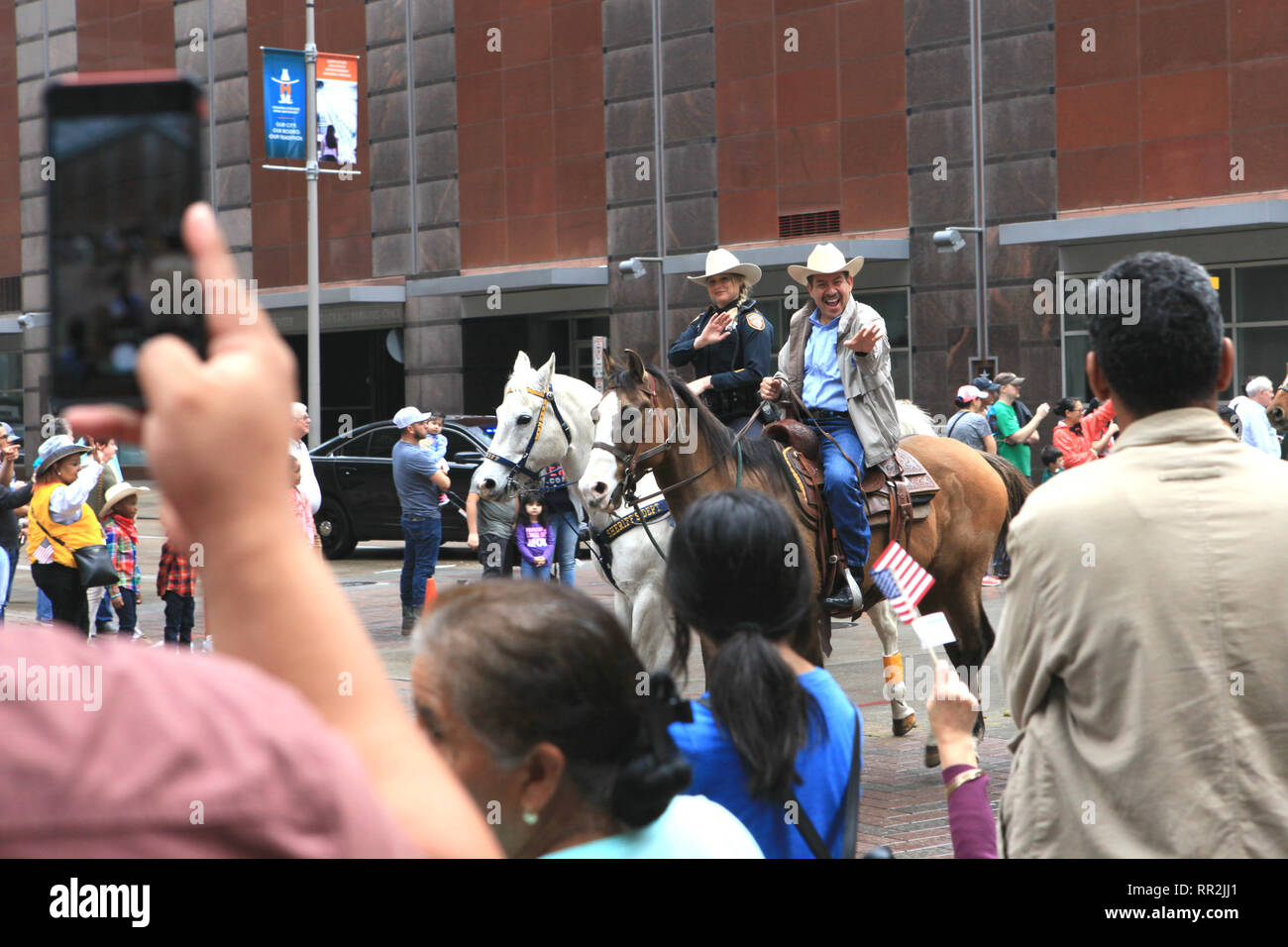 Houston, USA. 23rd Feb, 2019. Harris County police officers wave to the ...