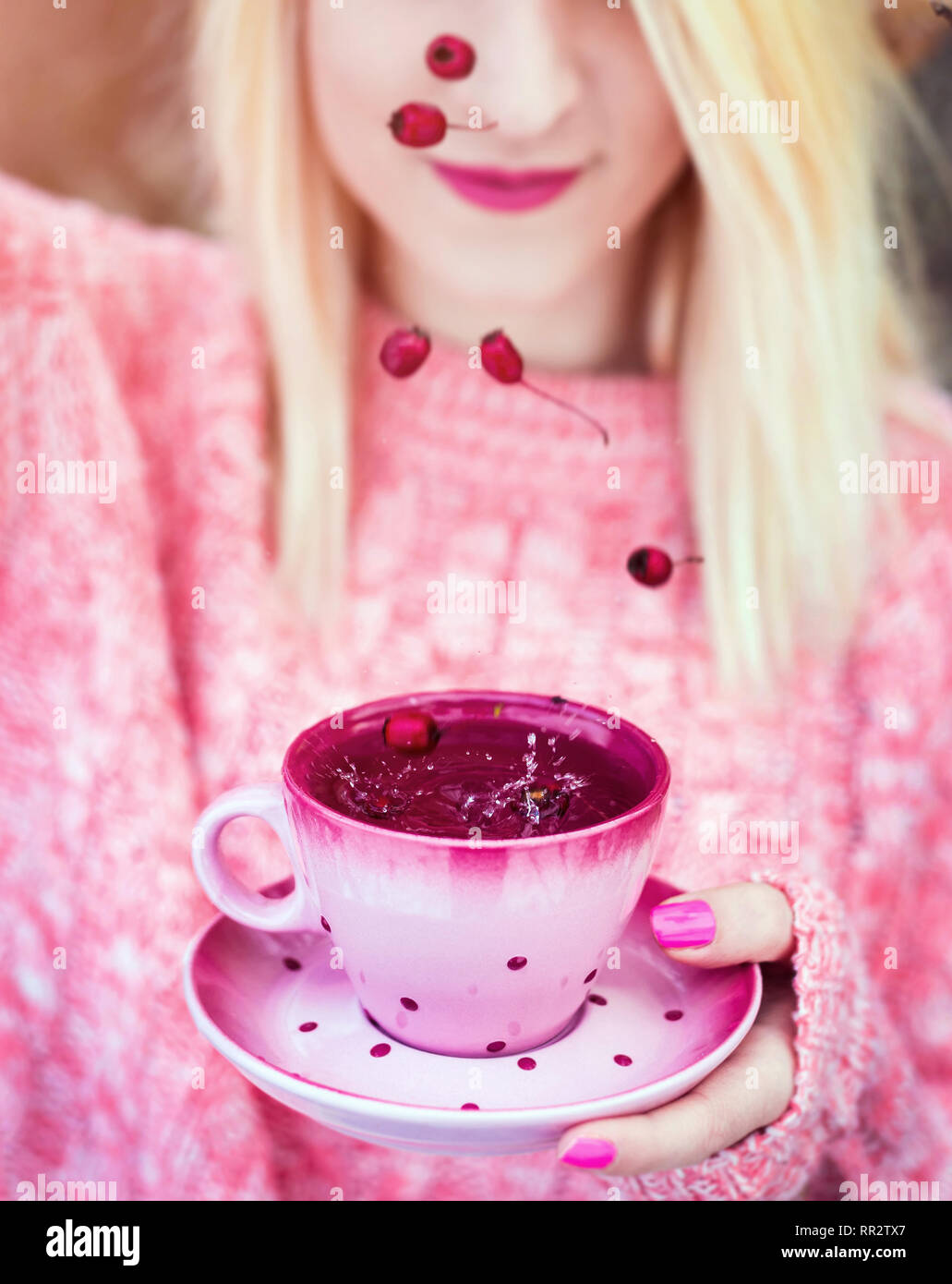 Berries falling into tea cup Stock Photo - Alamy