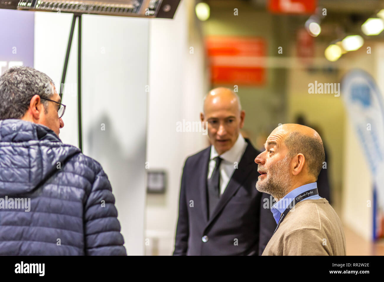 BOLOGNA, ITALY - FEBRUARY 18, 2019: booth presenter talking with ...