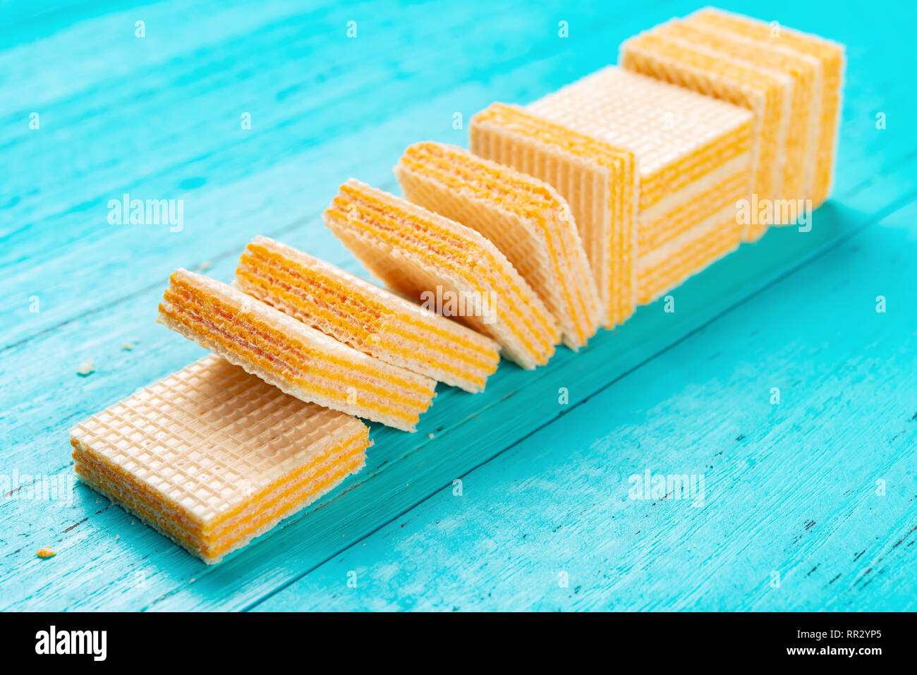 cheese wafer blocks on blue background Stock Photo - Alamy