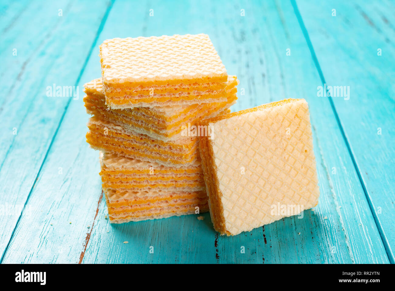 cheese wafer blocks stacked on blue background Stock Photo - Alamy