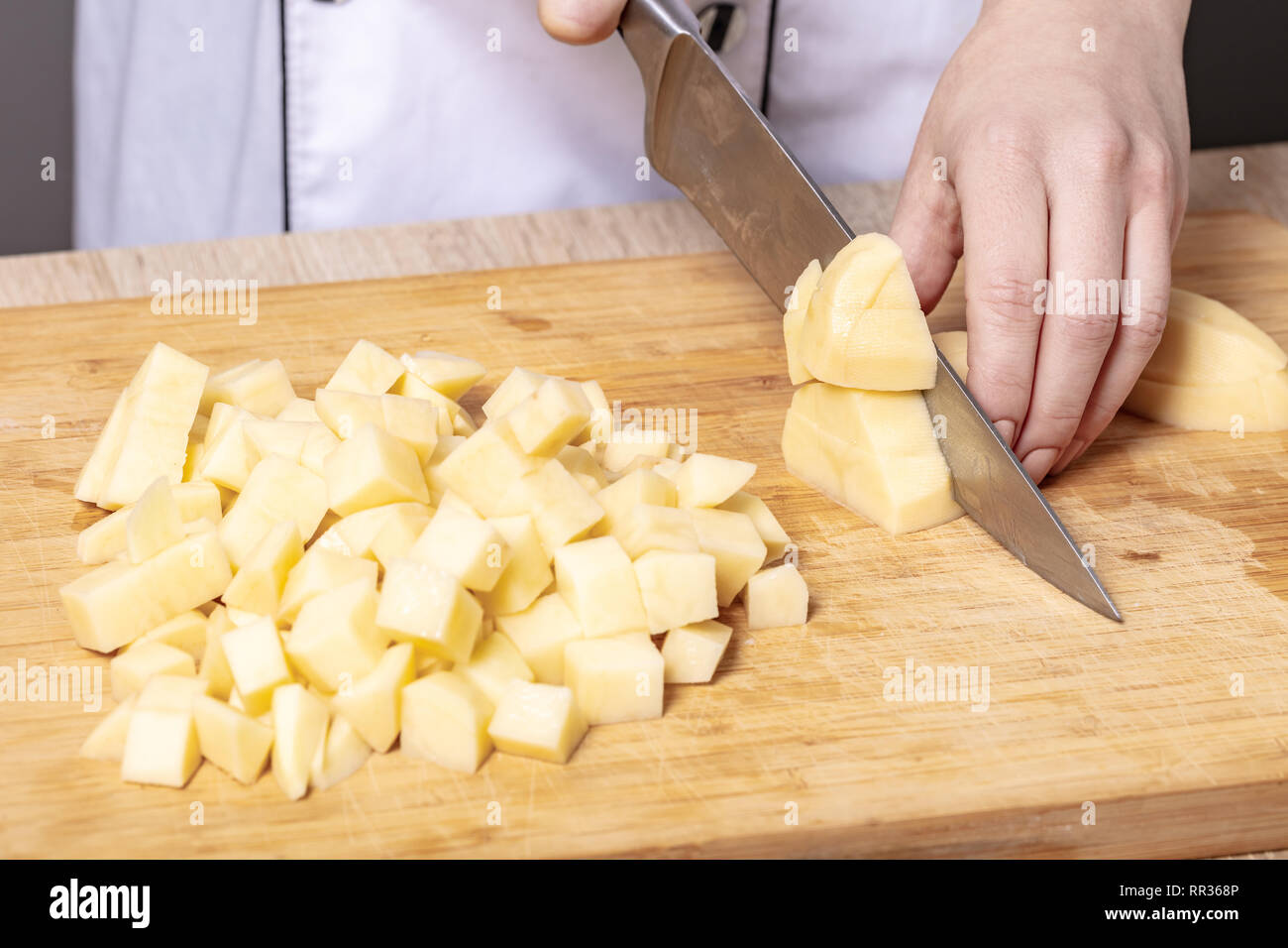 Cook cuts potatoes on hi-res stock photography and images - Alamy
