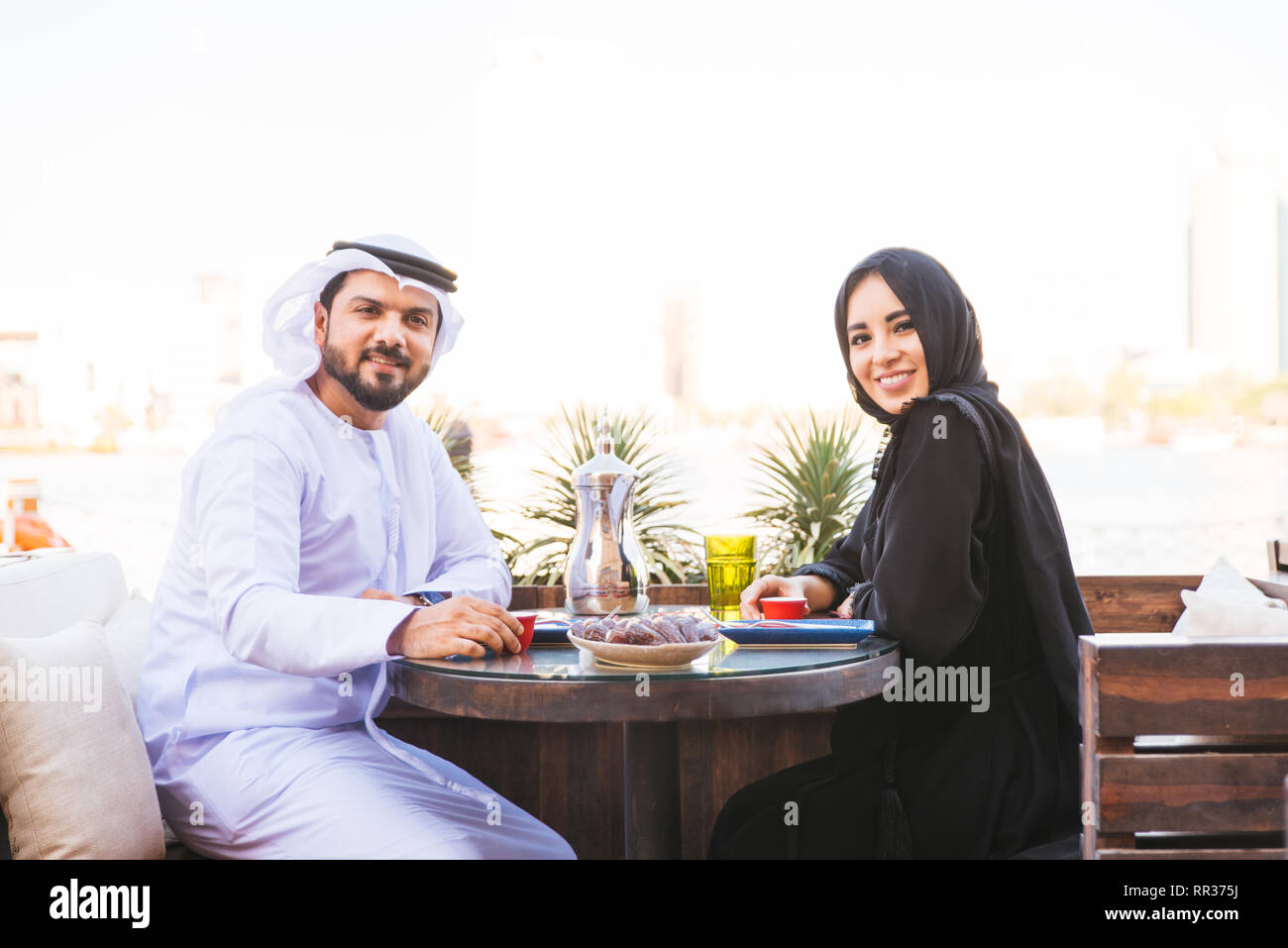 Arabian couple with traditional emirates dress dating outdoors - Happy ...