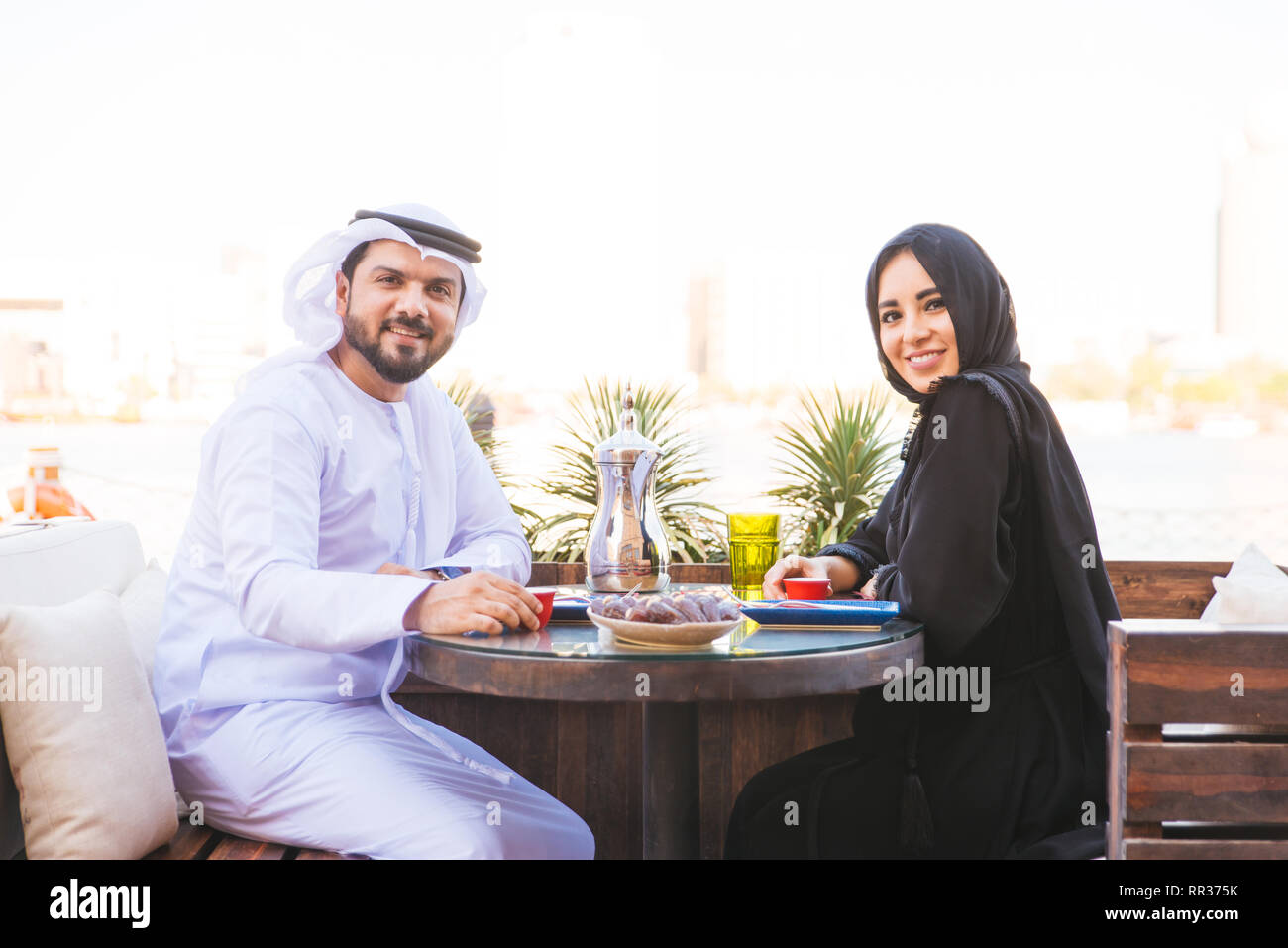 Arabian couple with traditional emirates dress dating outdoors - Happy ...