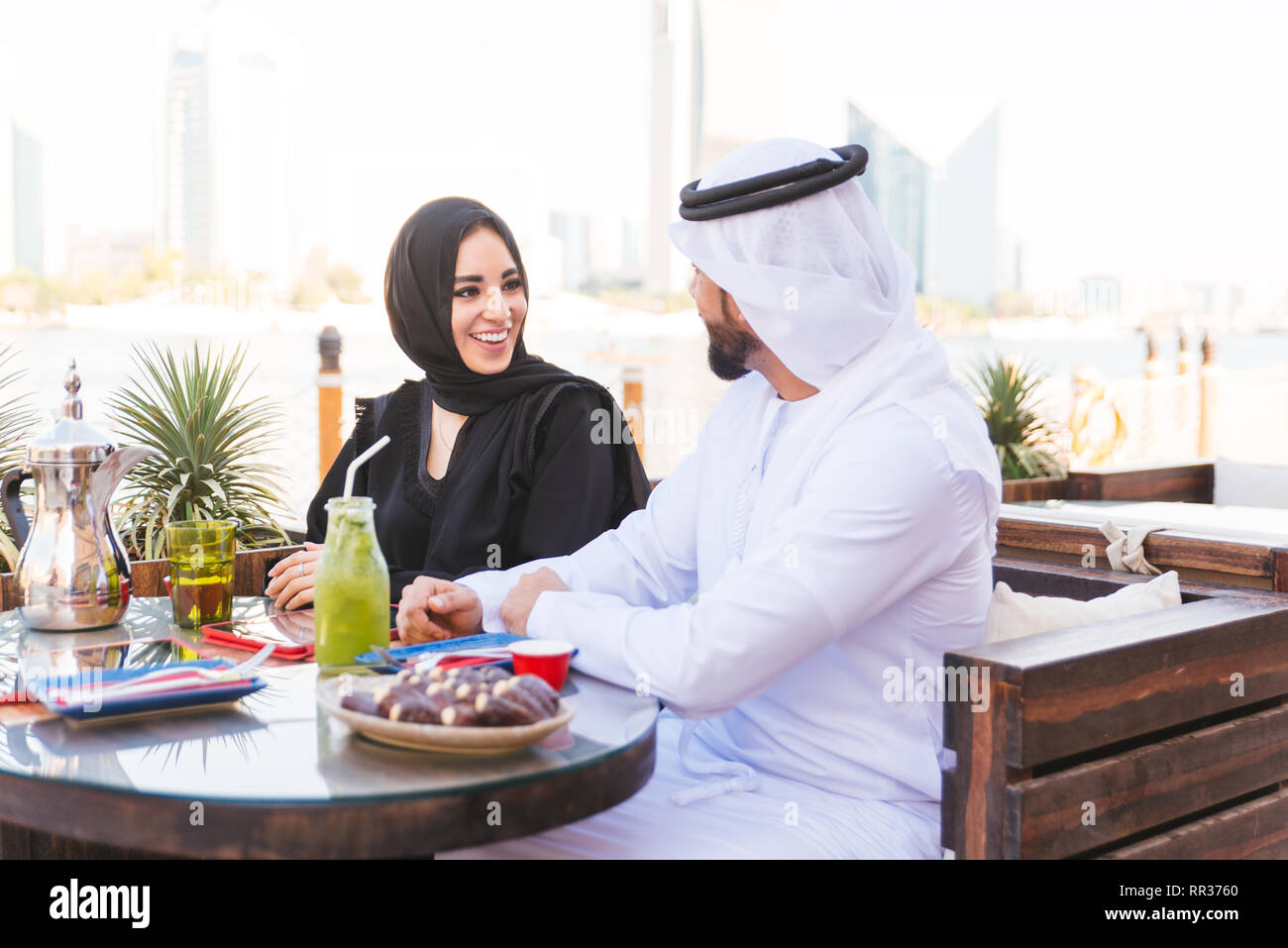 Arabian couple with traditional emirates dress dating outdoors - Happy ...