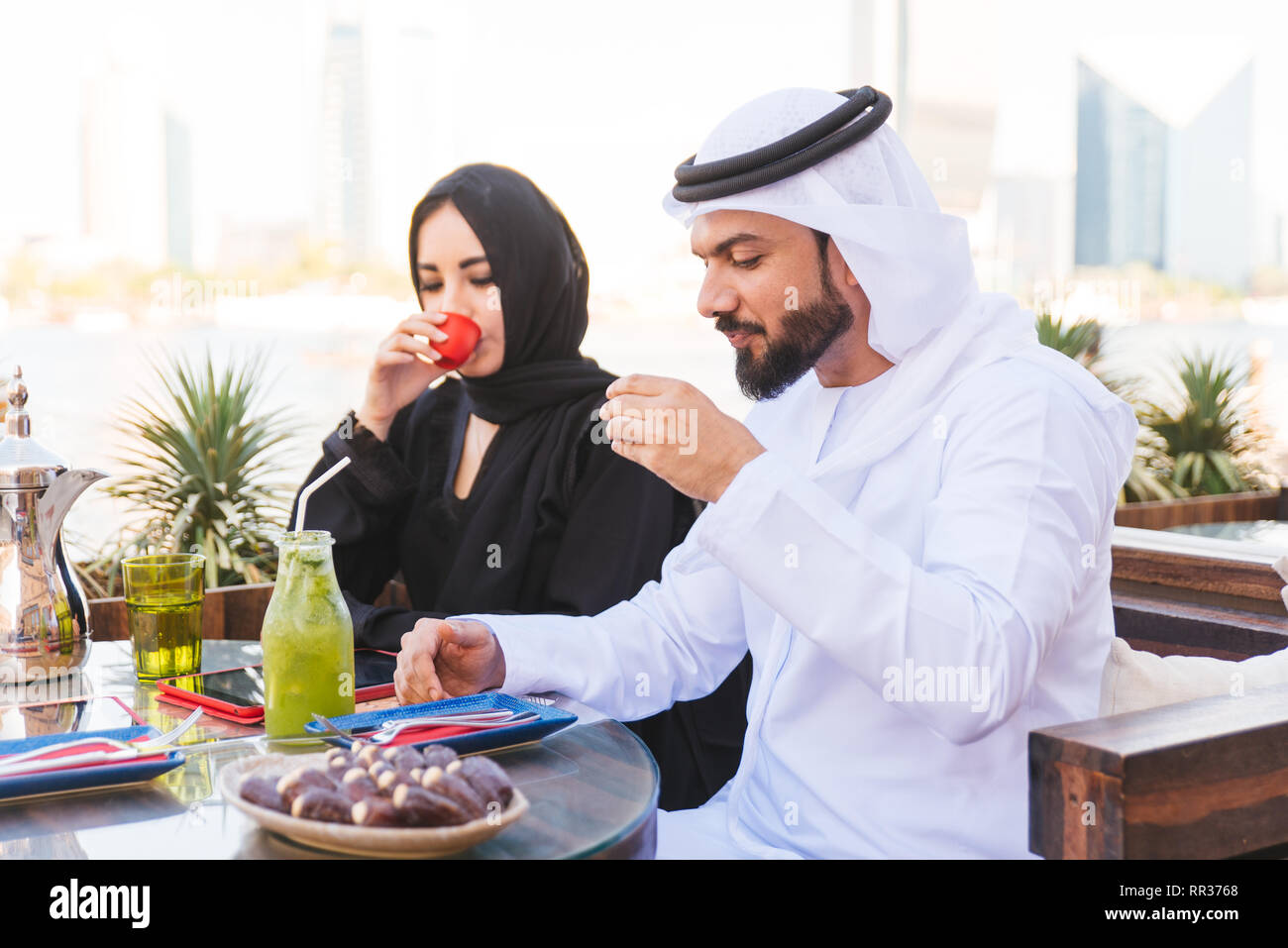 Arabian couple with traditional emirates dress dating outdoors - Happy ...