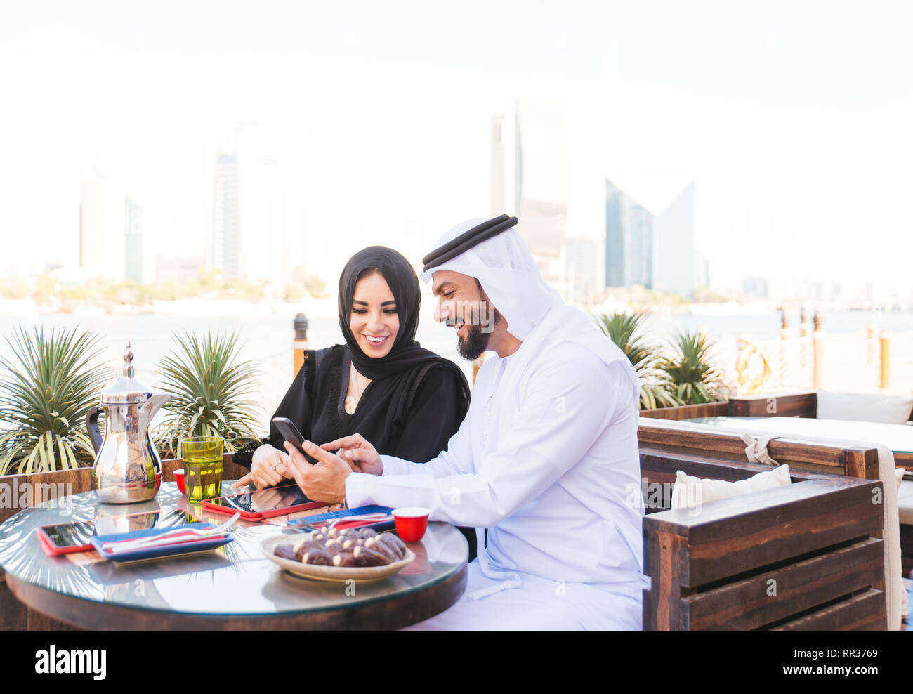 Arabian couple with traditional emirates dress dating outdoors - Happy ...
