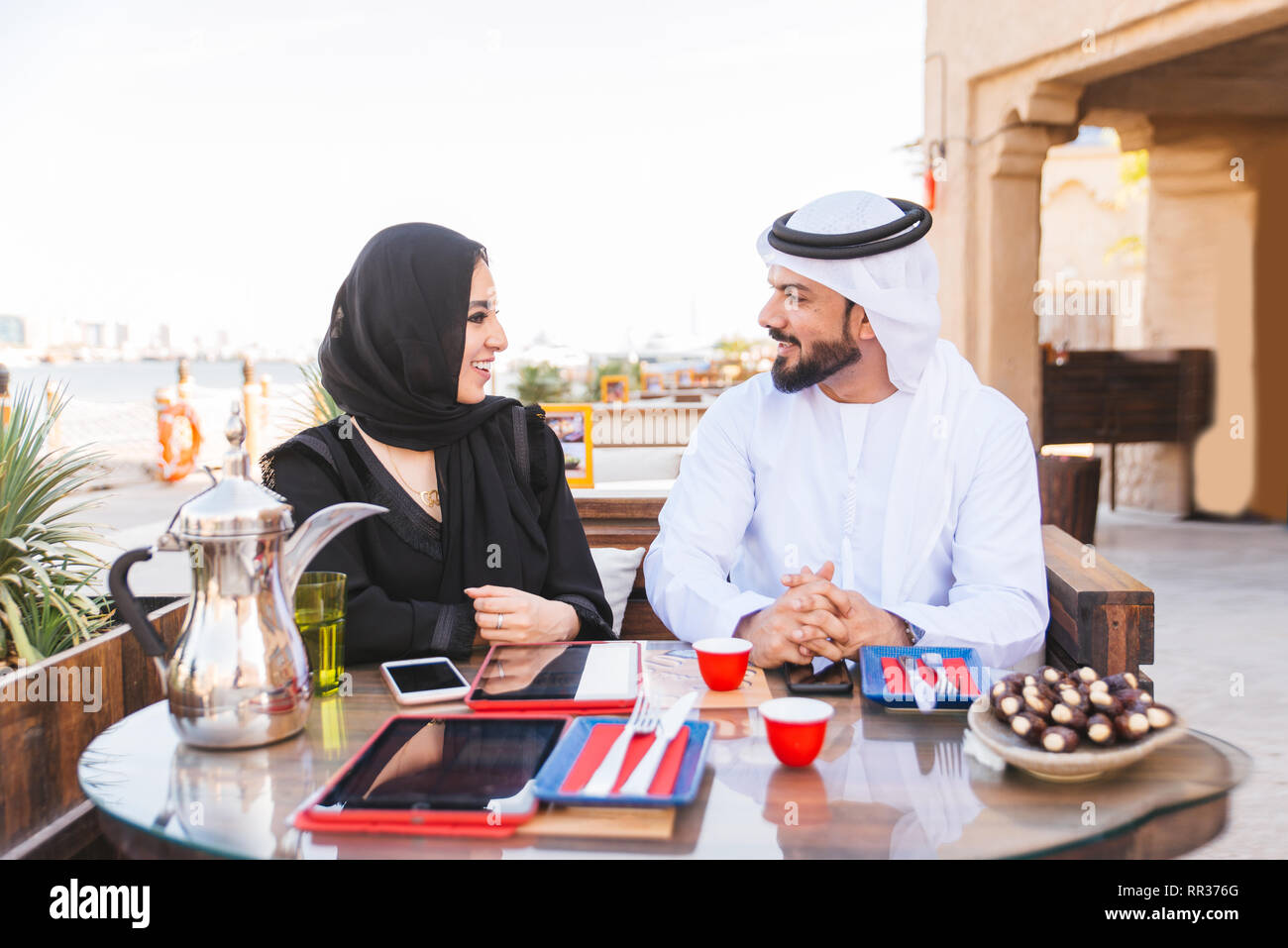 Arabian couple with traditional emirates dress dating outdoors - Happy ...