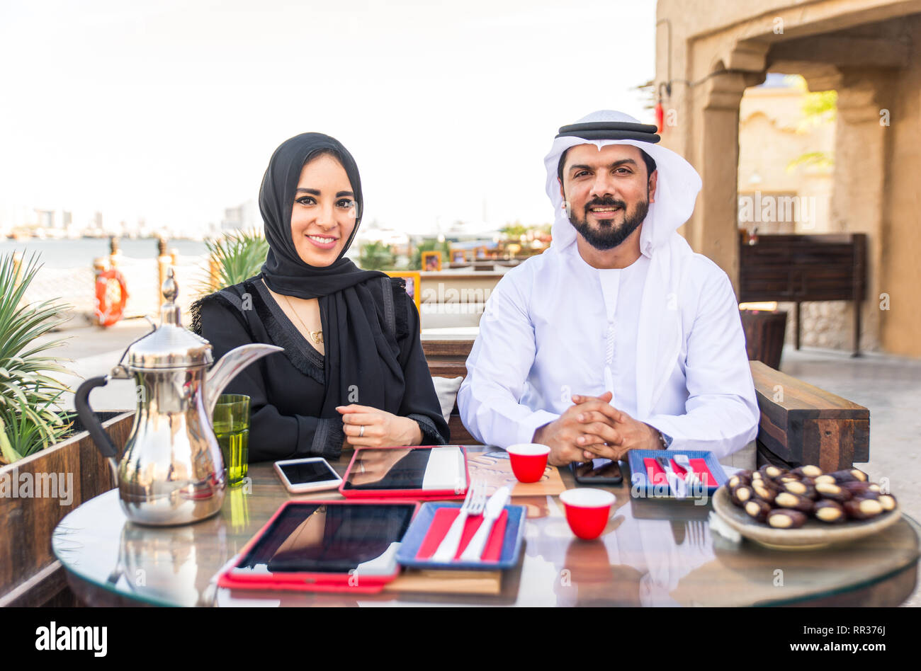 Arabian couple with traditional emirates dress dating outdoors - Happy ...