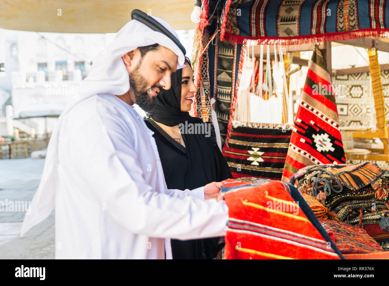 Arabian couple with traditional emirates dress dating outdoors - Happy ...
