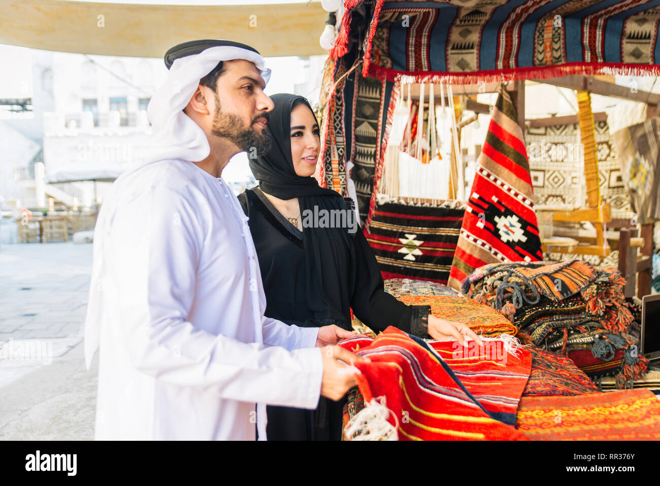 Arabian couple with traditional emirates dress dating outdoors - Happy ...