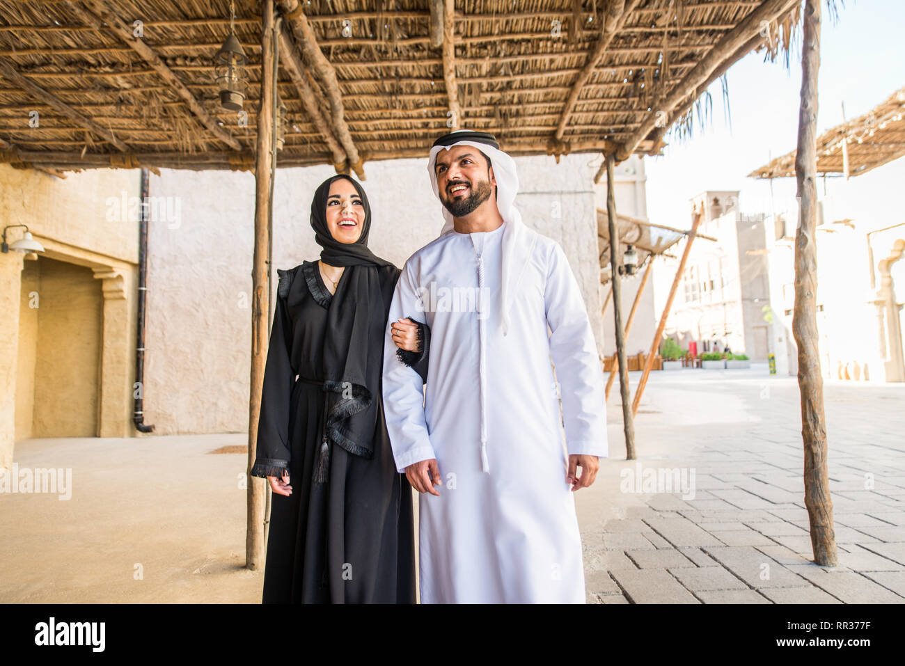 Arabian couple with traditional emirates dress dating outdoors - Happy ...