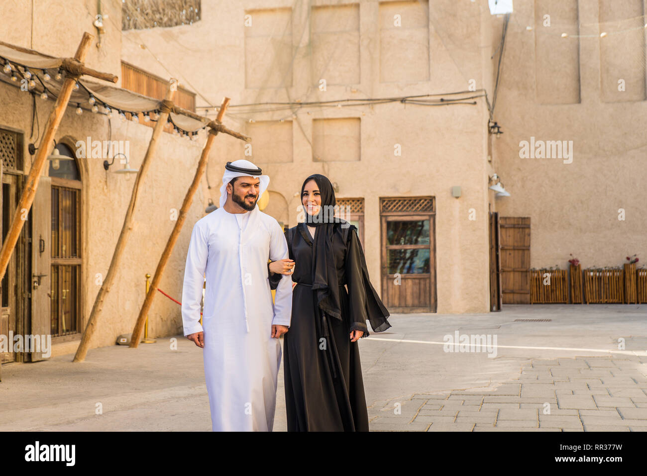 Arabian couple with traditional emirates dress dating outdoors - Happy ...