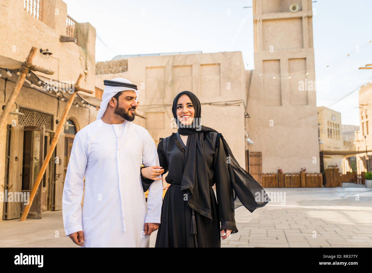 Arabian couple with traditional emirates dress dating outdoors - Happy ...