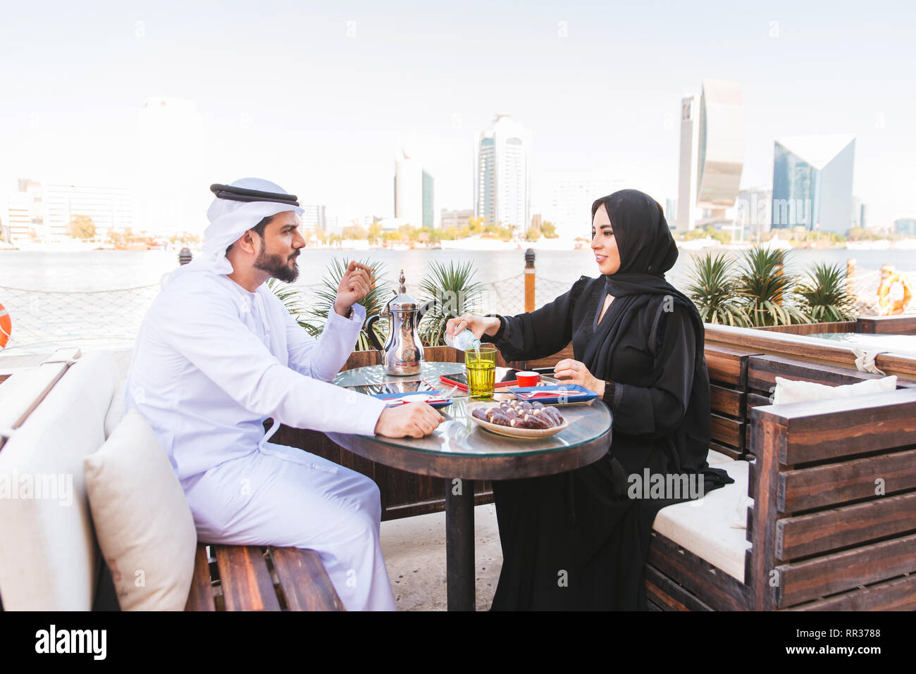 Arabian couple with traditional emirates dress dating outdoors - Happy ...
