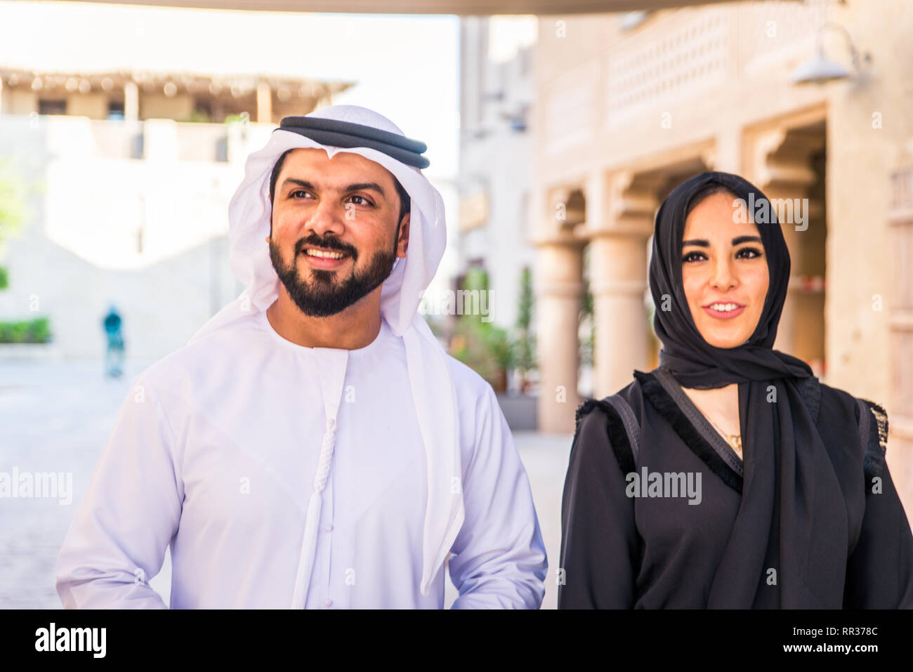 Arabian couple with traditional emirates dress dating outdoors - Happy ...