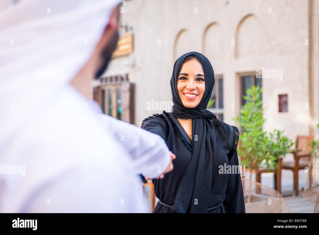 Arabian couple with traditional emirates dress dating outdoors - Happy ...