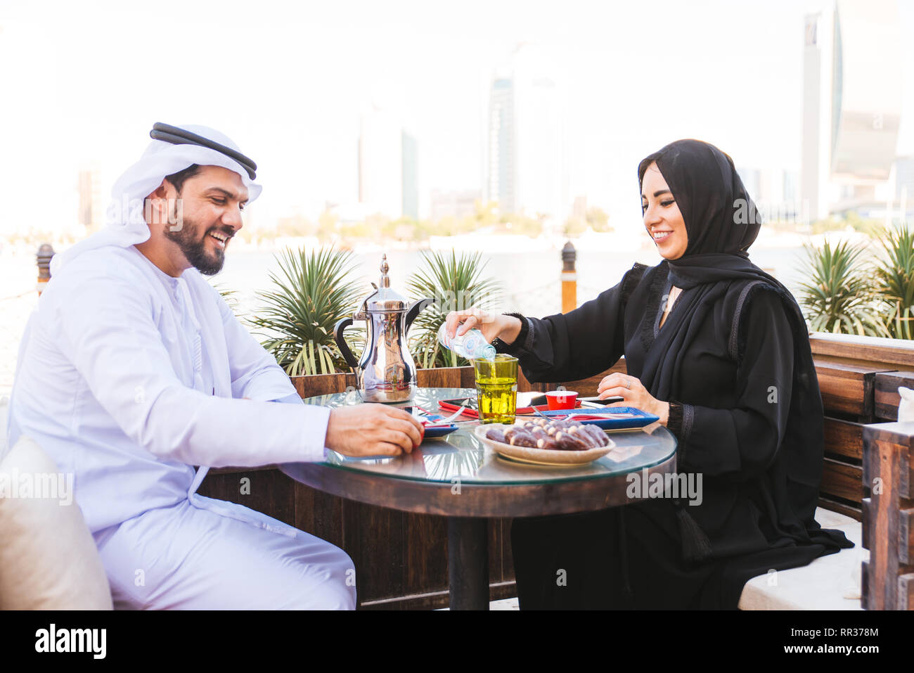 Arabian couple with traditional emirates dress dating outdoors - Happy ...