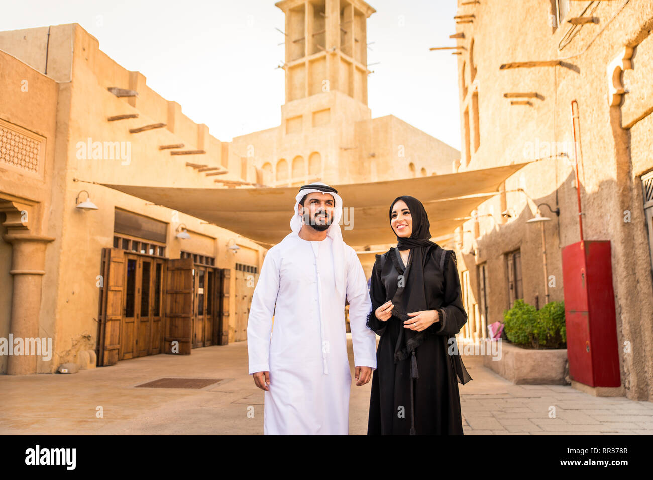Arabian couple with traditional emirates dress dating outdoors - Happy ...
