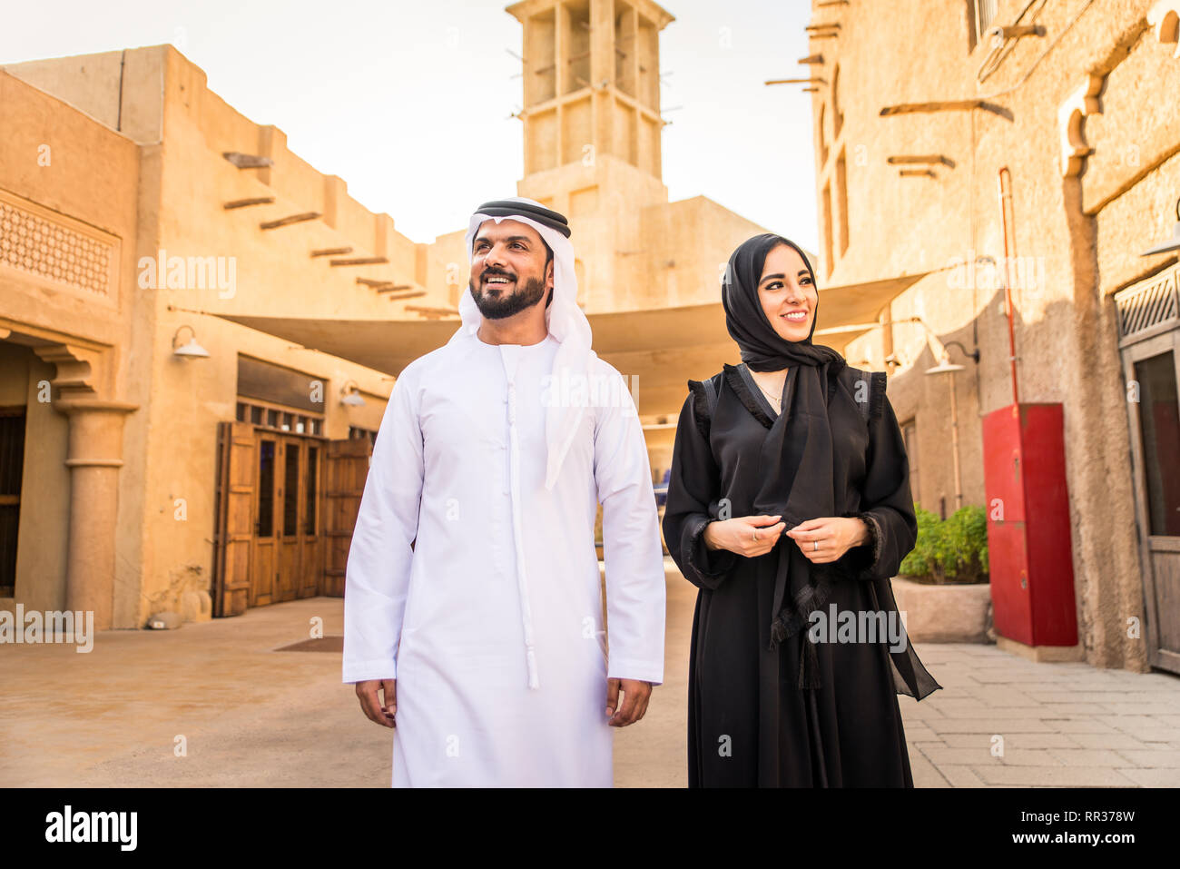 Arabian couple with traditional emirates dress dating outdoors - Happy ...