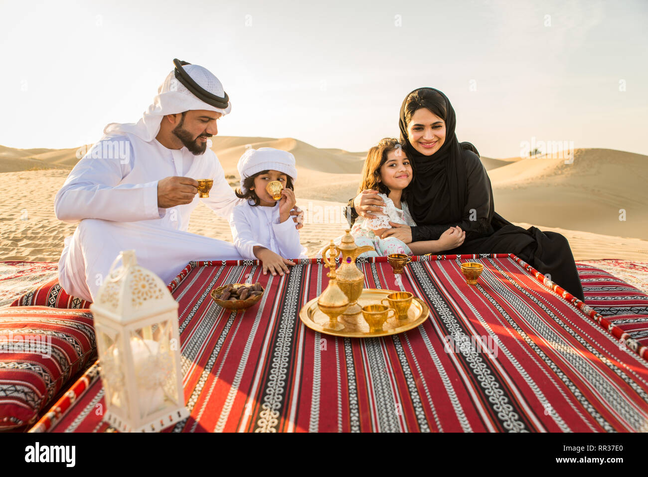 Arabian family with kids having fun in the desert - Parents and ...