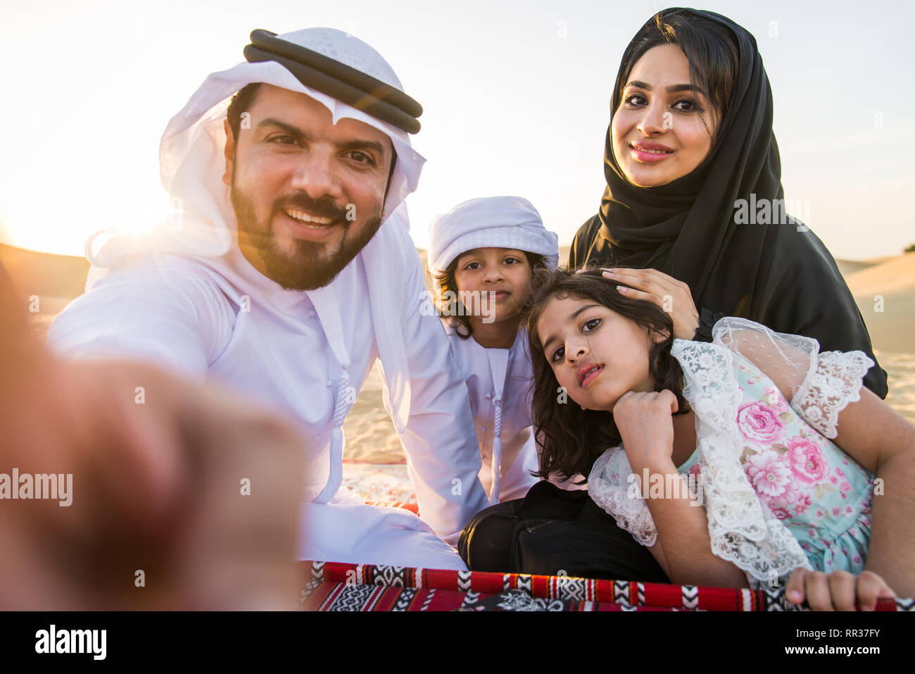 Arabian family with kids having fun in the desert - Parents and ...