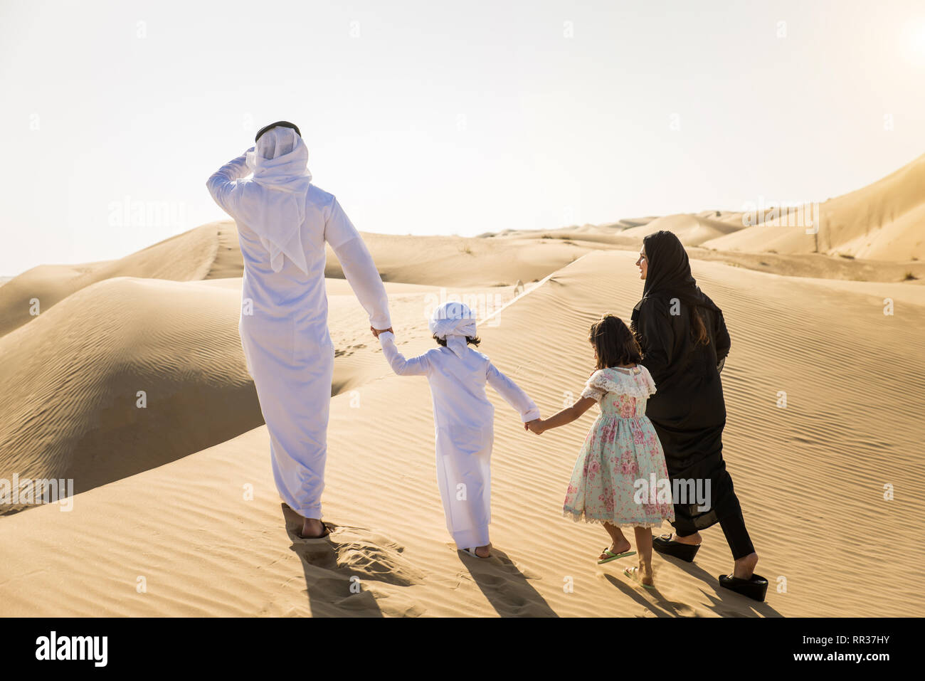 Arabian family with kids having fun in the desert - Parents and ...