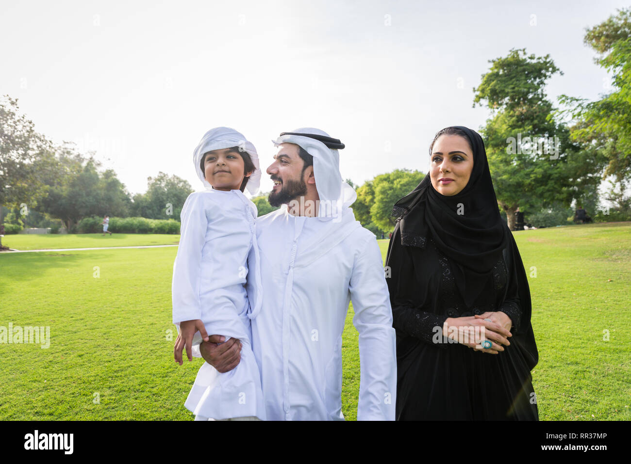 Happy middle-eastern family having fun in a park in Dubai - Parents and ...