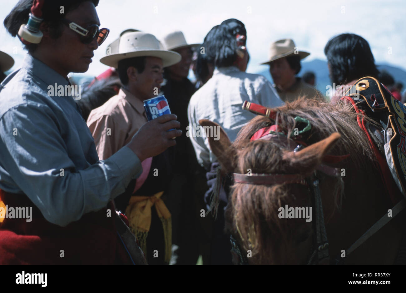 Litang, Sichuan, China - Aug 2003. A Tibetan khampa drinks a can of ...