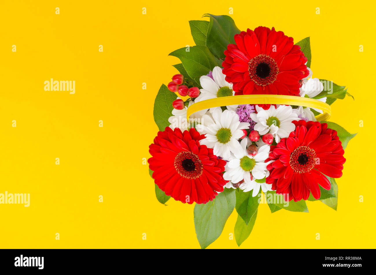 Gift basket with beautiful flowers on bright background. Studio Photo ...