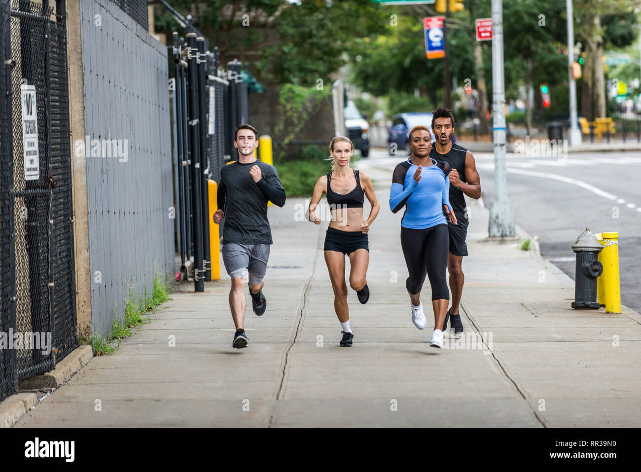 Multi-ethnic group of runners training outdoors - Sportive people ...