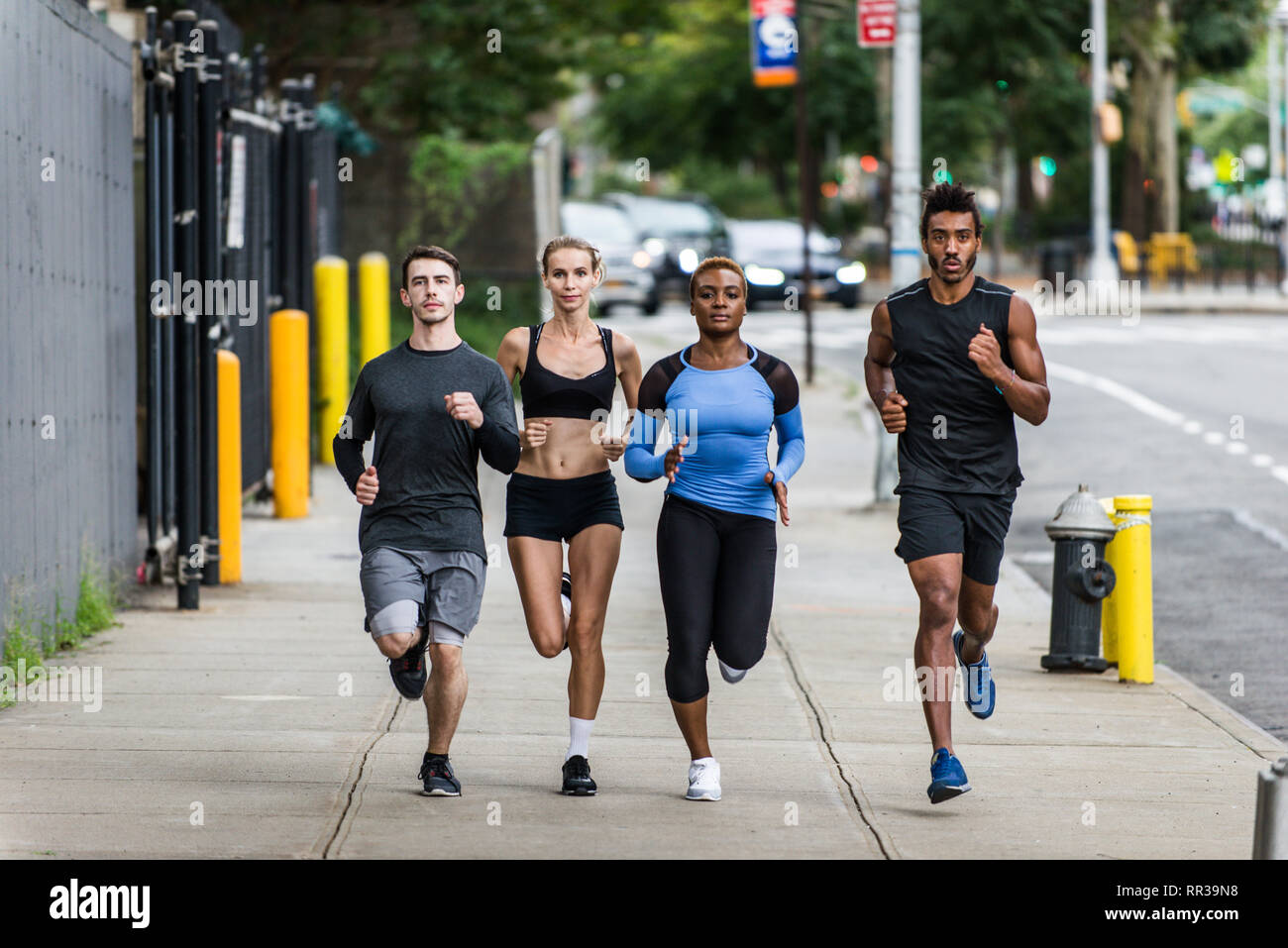 Multi-ethnic group of runners training outdoors - Sportive people ...
