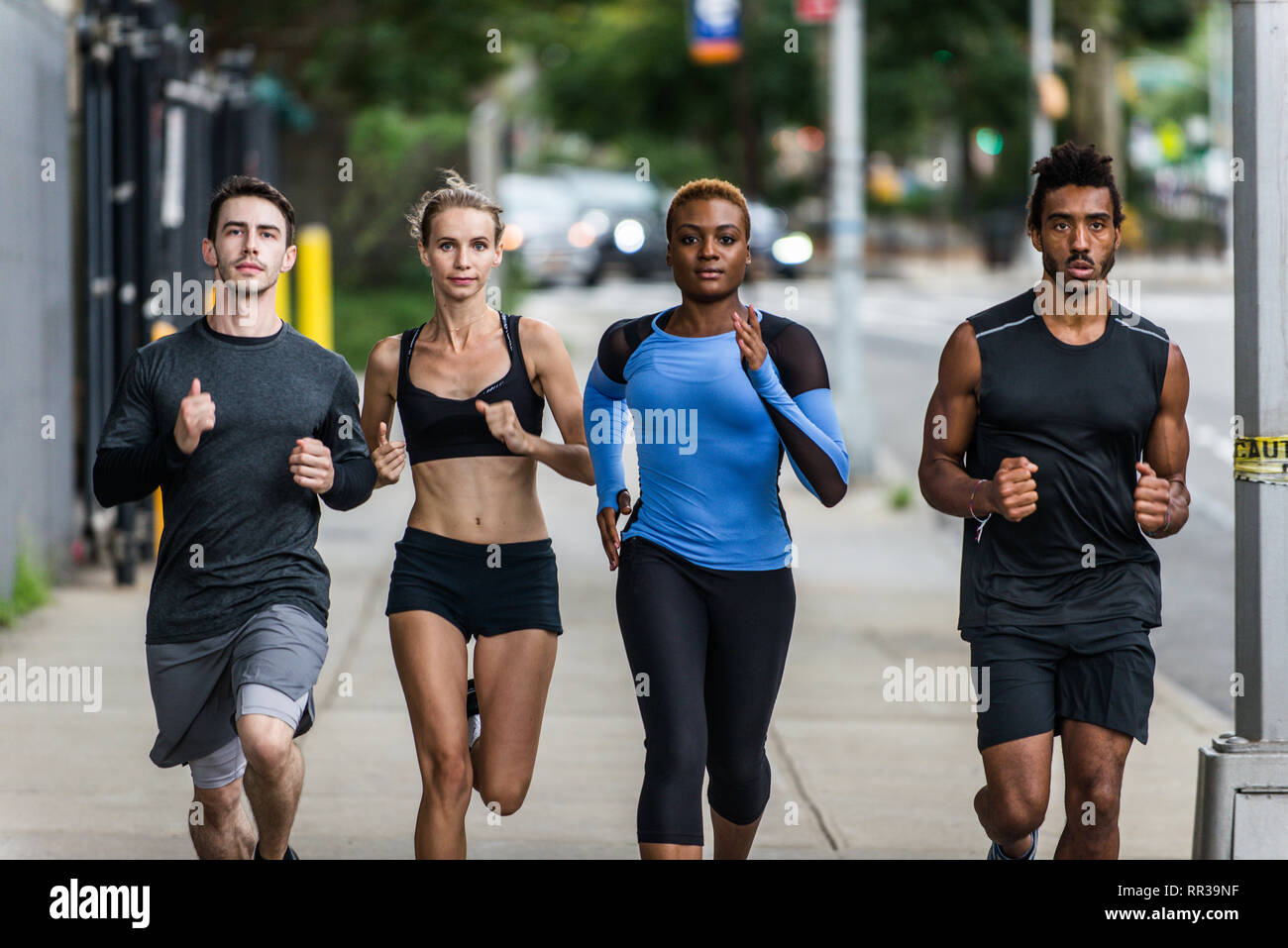 Multi-ethnic group of runners training outdoors - Sportive people ...
