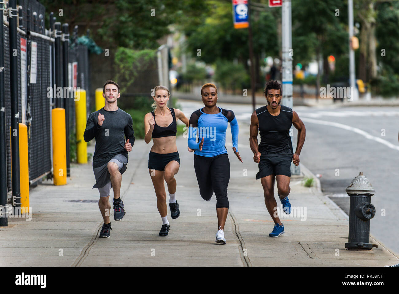Multi-ethnic group of runners training outdoors - Sportive people ...