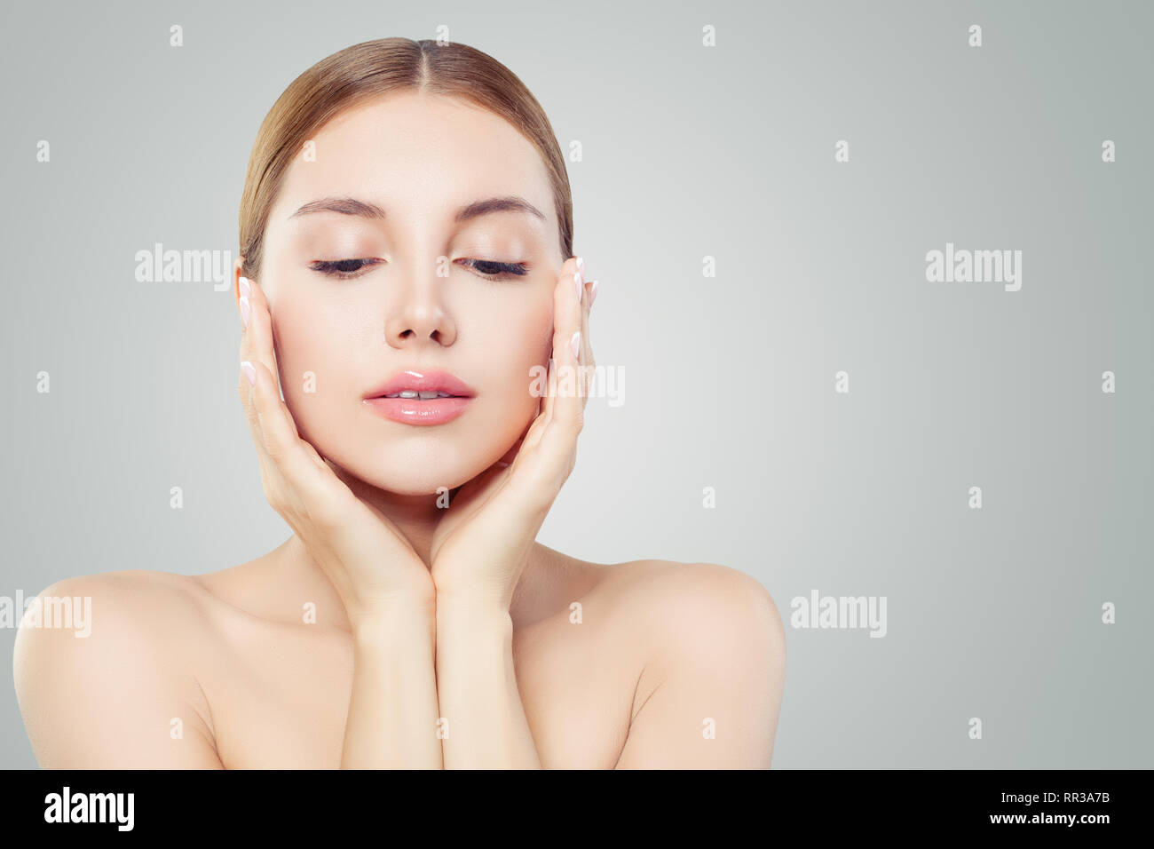 Perfect woman face. Beautiful girl touching her face her hands. Facial ...