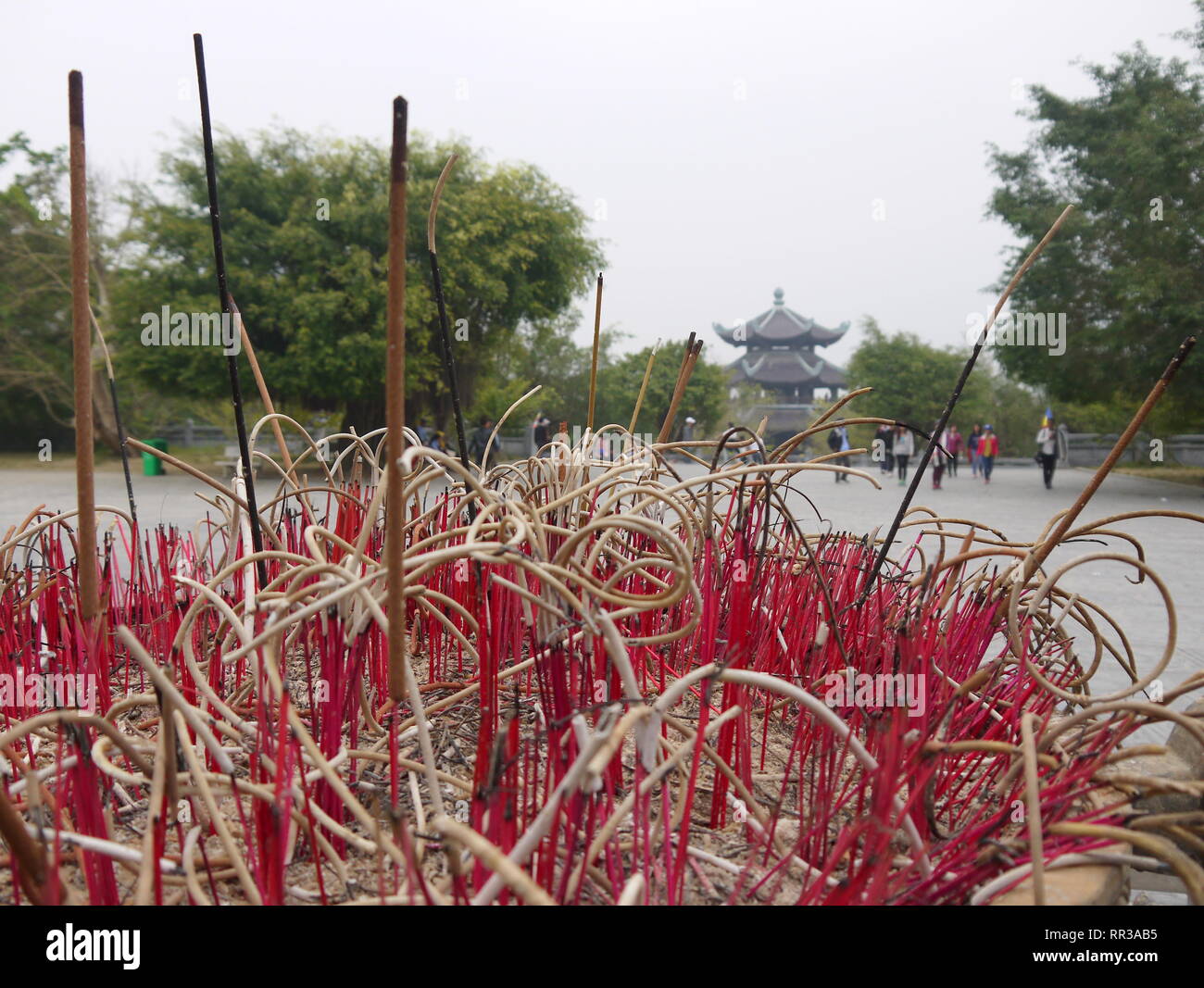 Burning red incense sticks in a huge pot at a temple near Hanoi Stock ...
