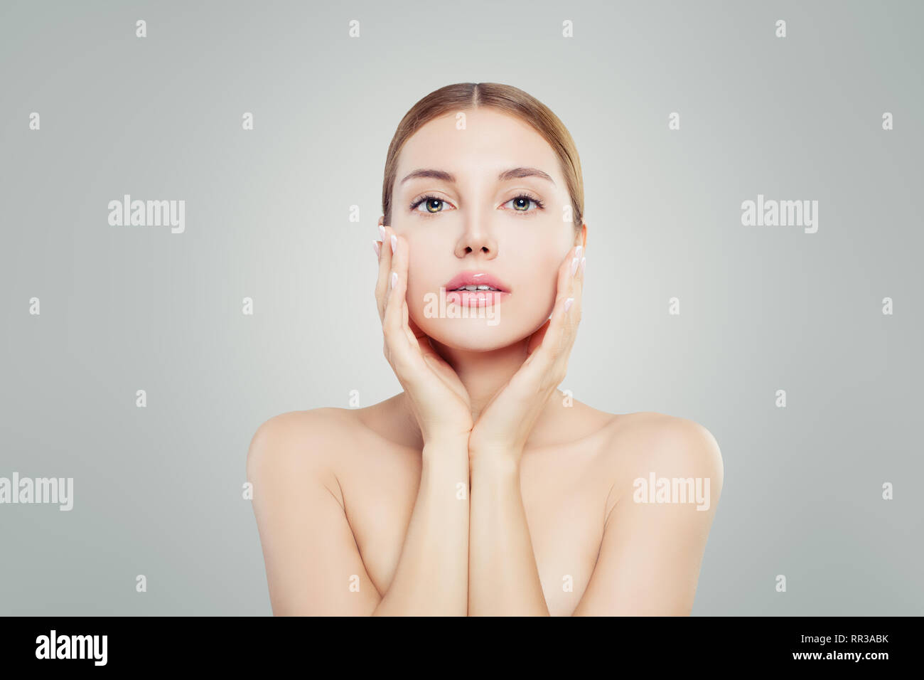 Beautiful model woman touching her face in cheeks area. Facial ...