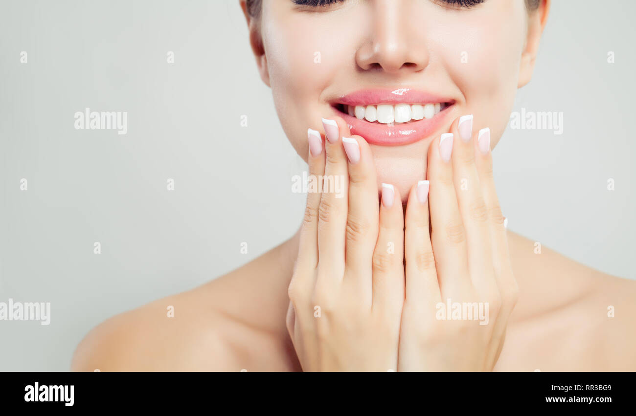 Young woman face closeup. Pink glossy female lips with natural makeup ...