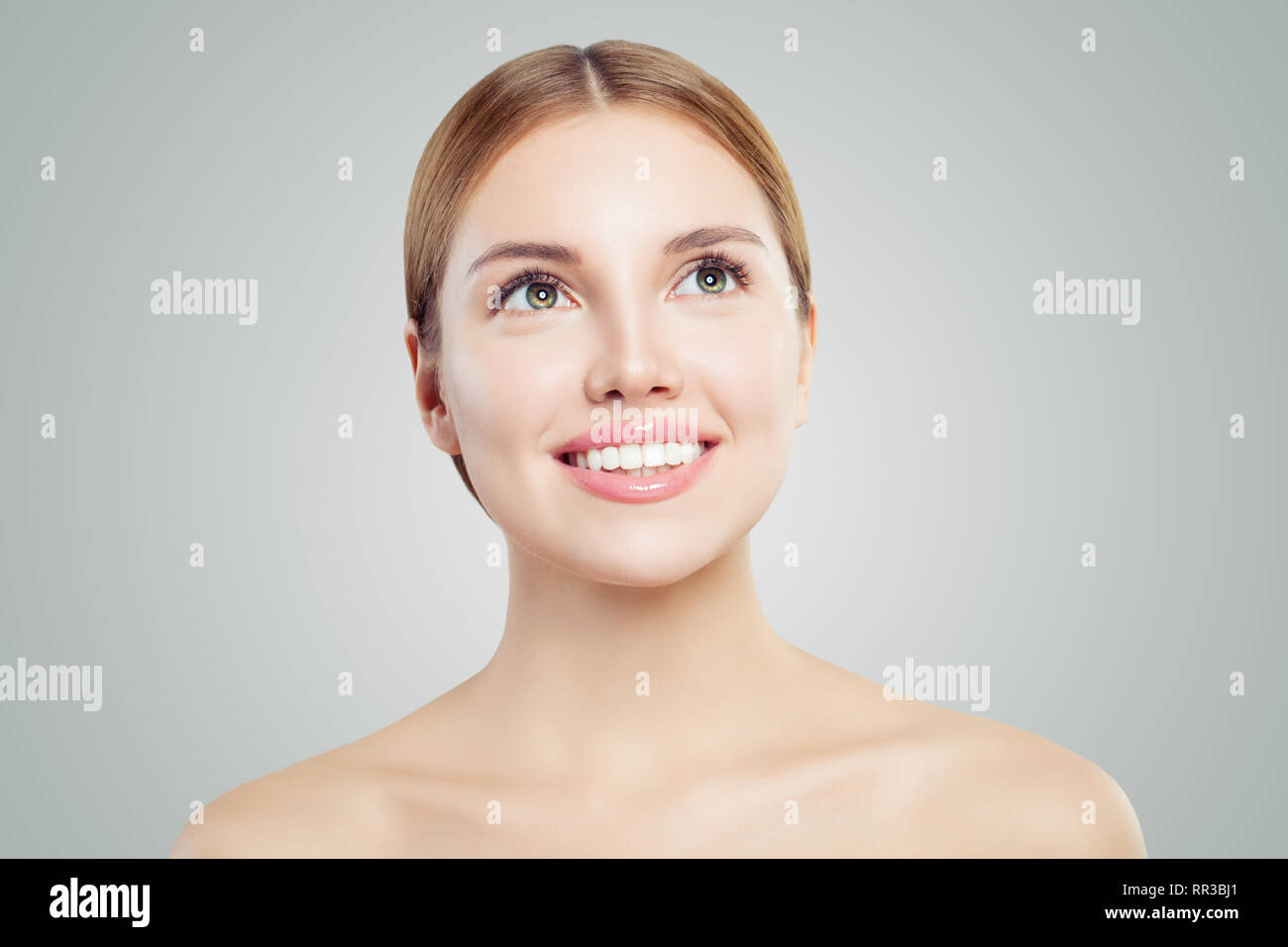Beautiful face. Young perfect woman looking up, closeup portrait on ...