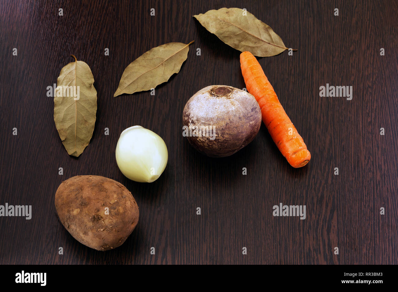 Raw vegetables and Bay leaves await culinary processing for the ...