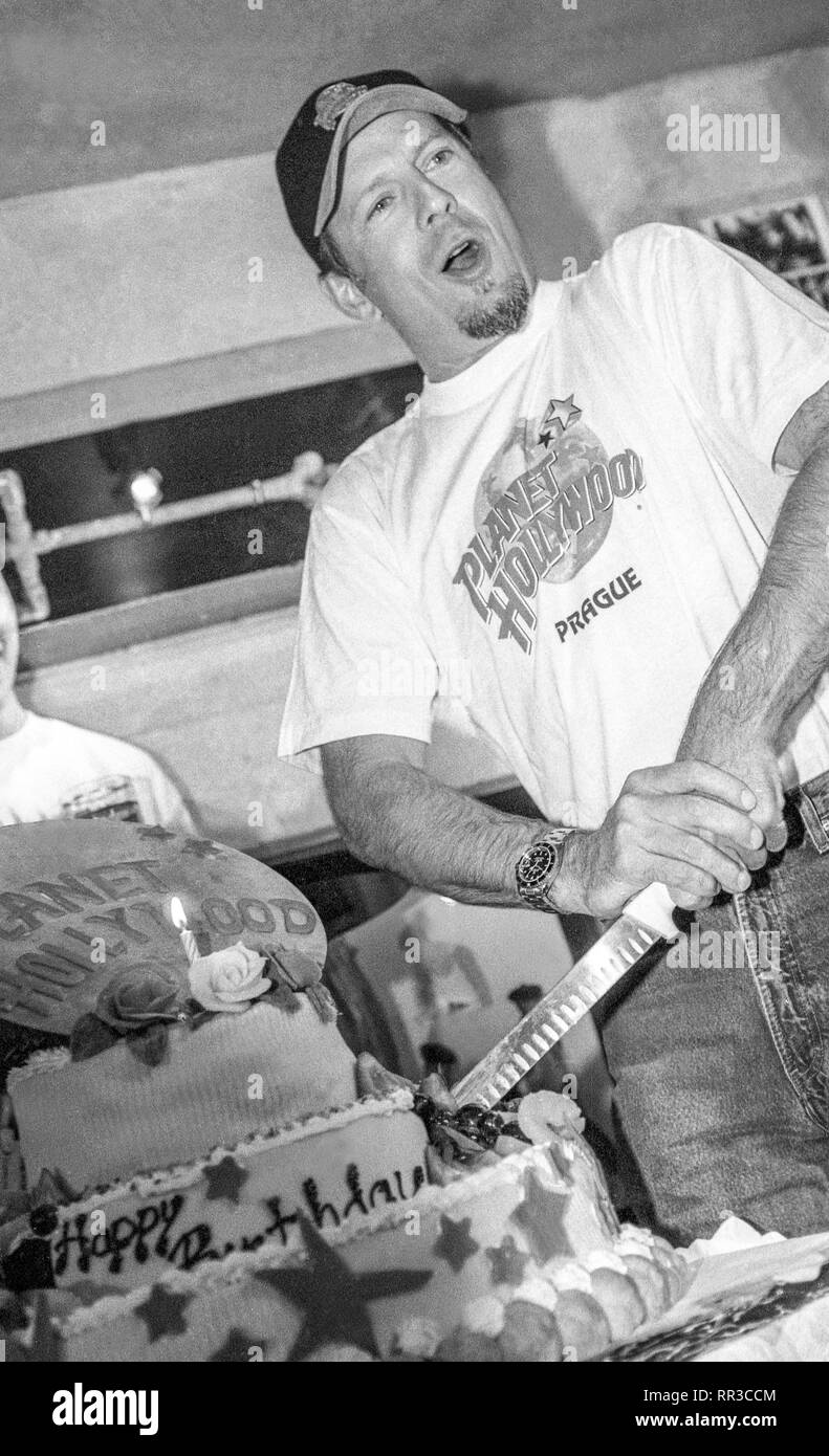 American actor Bruce Willis slices a cake at Planet Hollywood in Prague ...