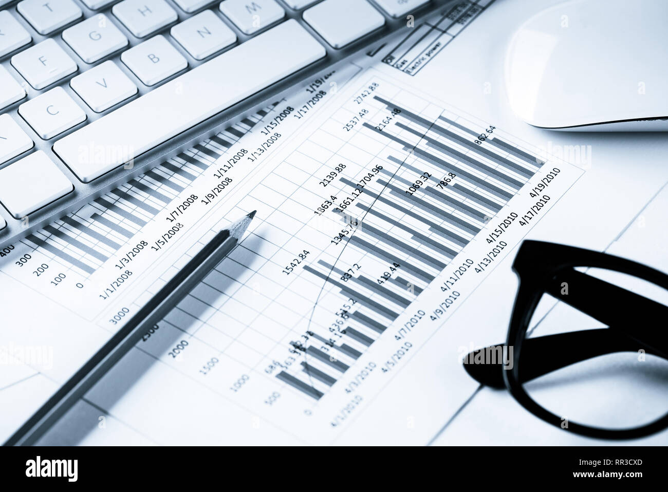 Business workplace with keyboard mouse and papers with graphs and ...